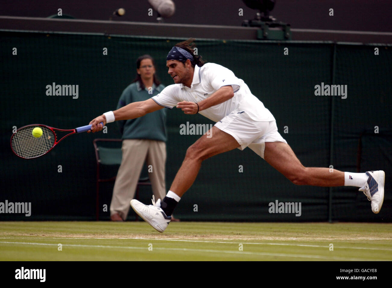 Tennis - Wimbledon 2002 - Fourth Round. Mark Philippoussis lunges for a ...