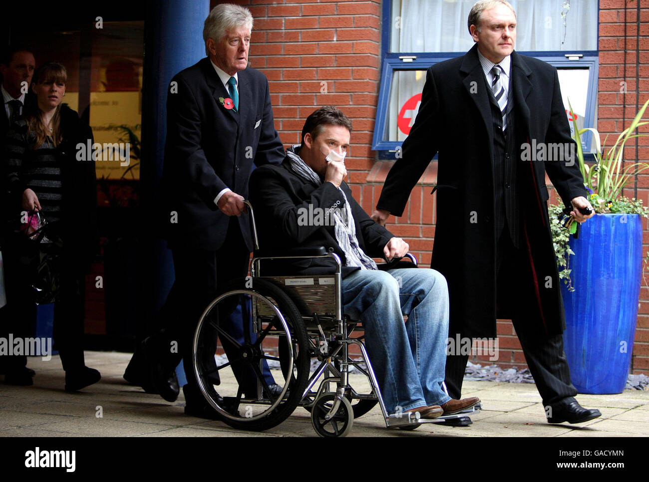 Opera singer Russell Watson is led from Alexandra Hospital in Cheadle ...