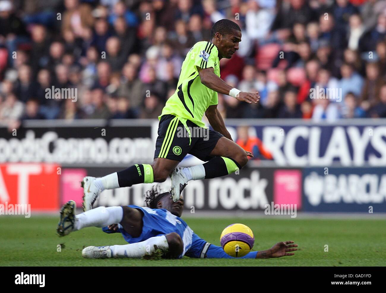 Chelseas florent malouda challenged by wigan athletics mario melchiot ...