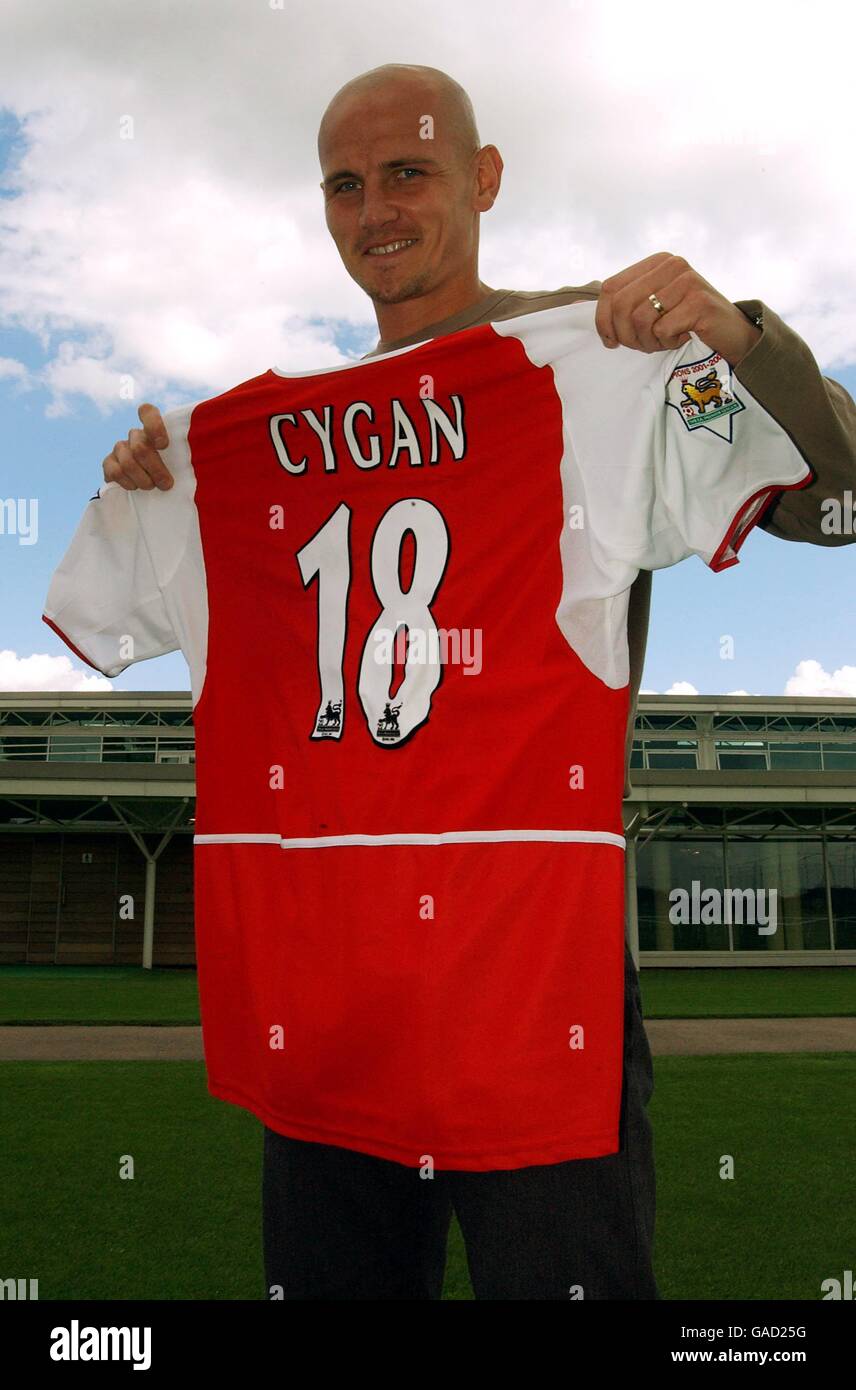 Pascal cygan holds his new shirt after signing to arsenal hi-res stock ...