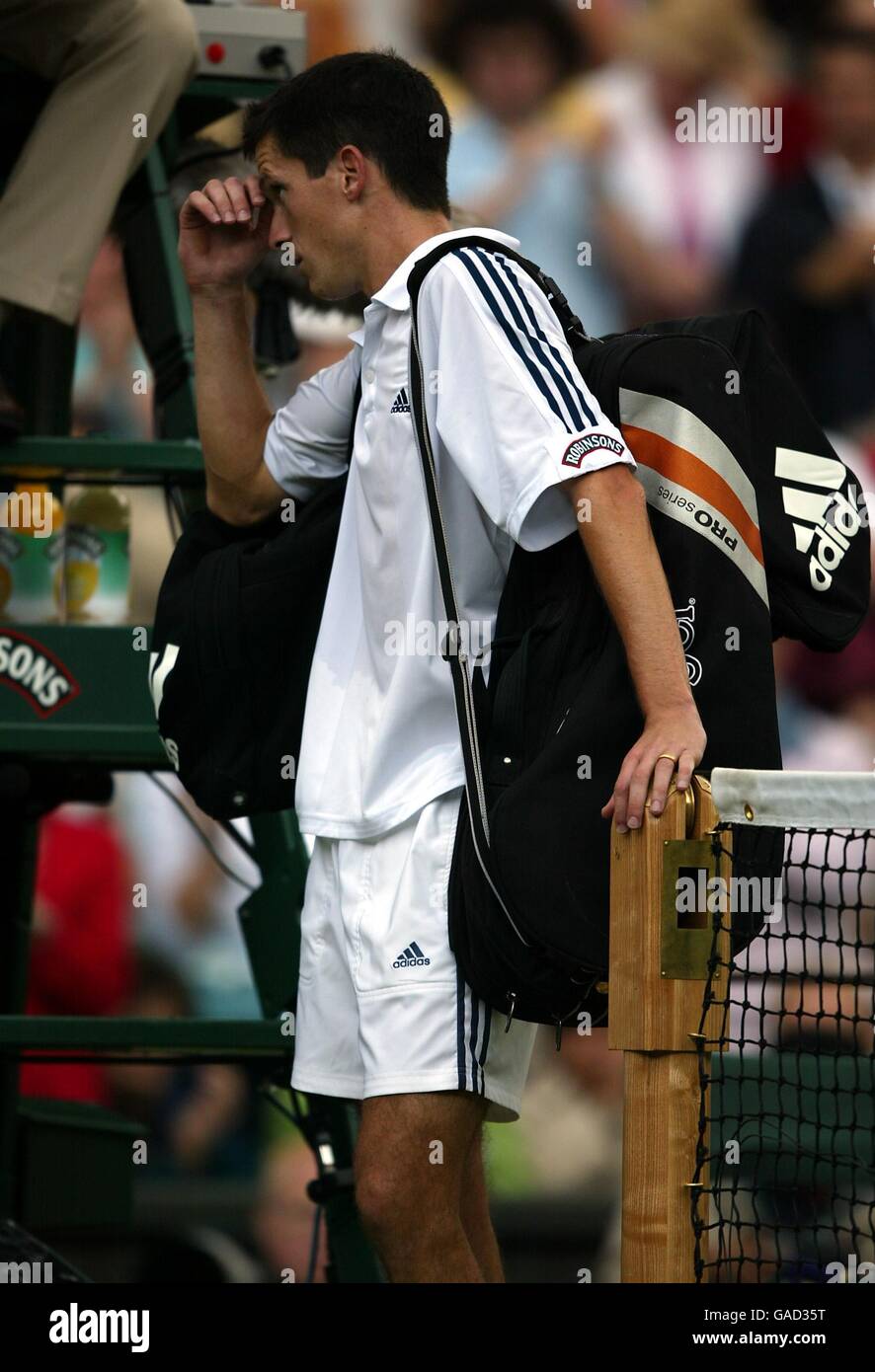 Tennis - Wimbledon 2002 - Mens Semi- Final. A dejected Tim Henman leans ...