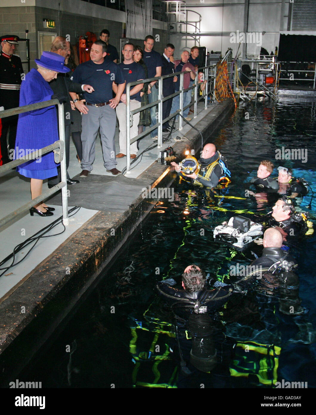 Britain's Queen Elizabeth II, left, meets divers working at the ...