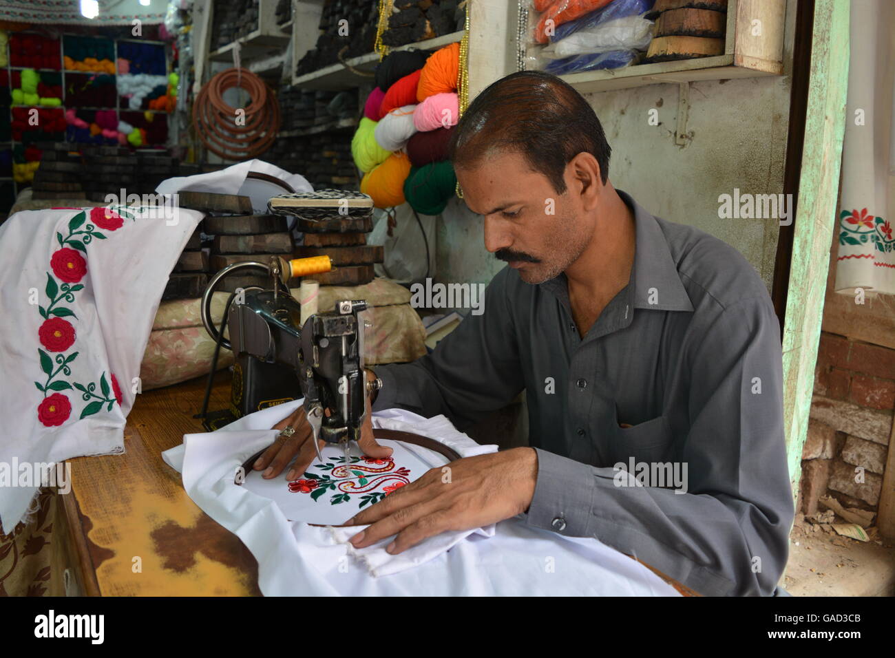 Man designing embroidery Stock Photo - Alamy