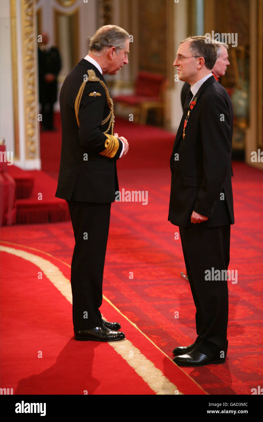 Commander Roy Hill is made an OBE by the Prince of Wales at Buckingham ...
