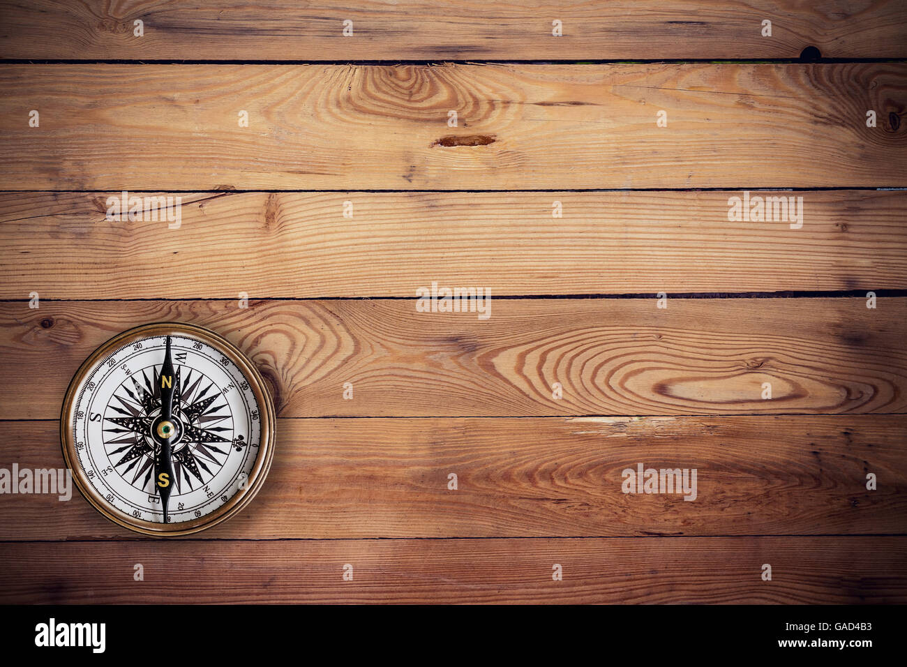 old compass on wood background and texture with space Stock Photo - Alamy