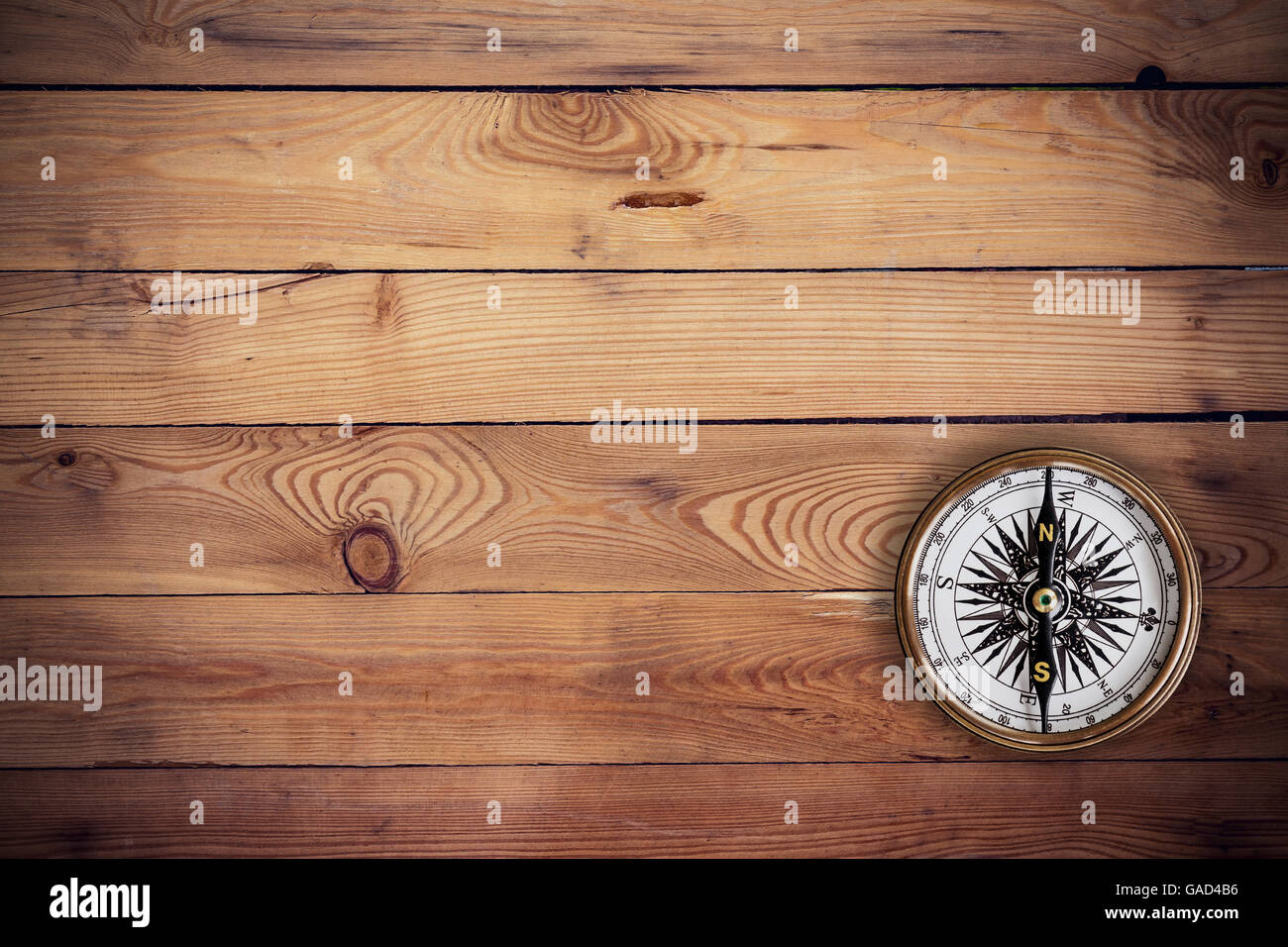 old compass on wood background and texture with space Stock Photo - Alamy