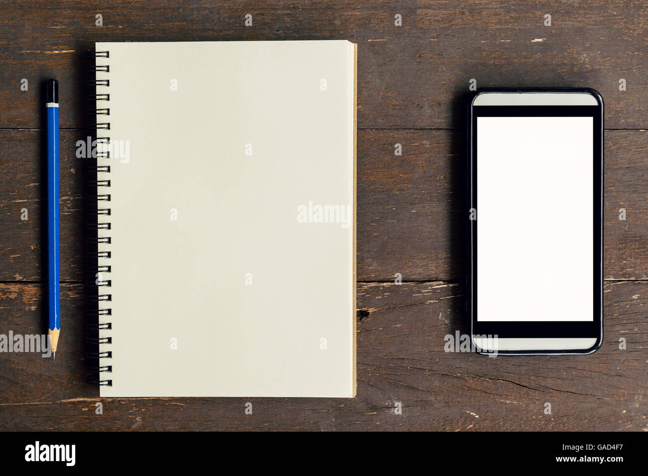 Top view above notebook and pencil with phone on wood table Stock Photo ...