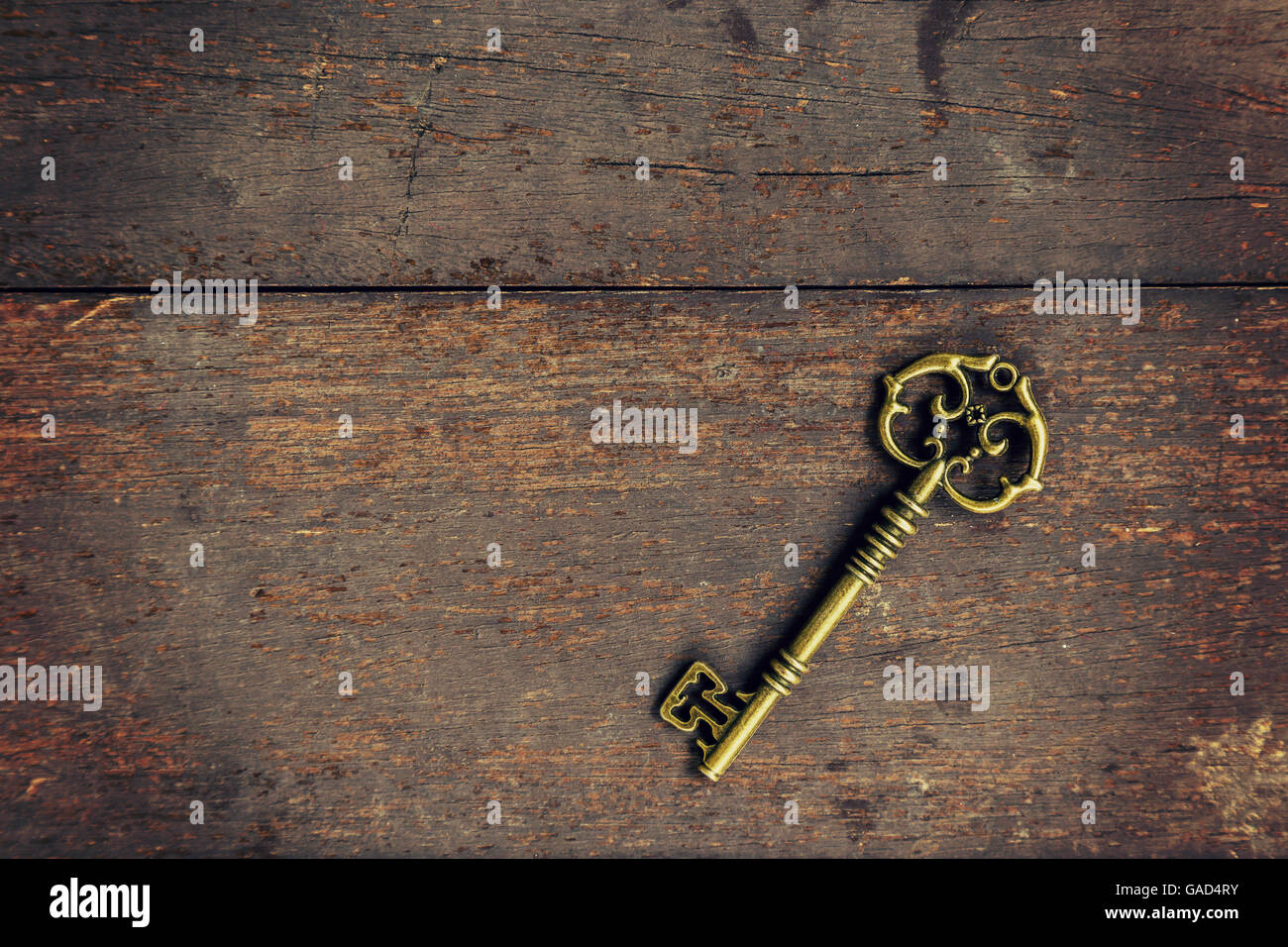 Old vintage key on wood texture background with space Stock Photo - Alamy