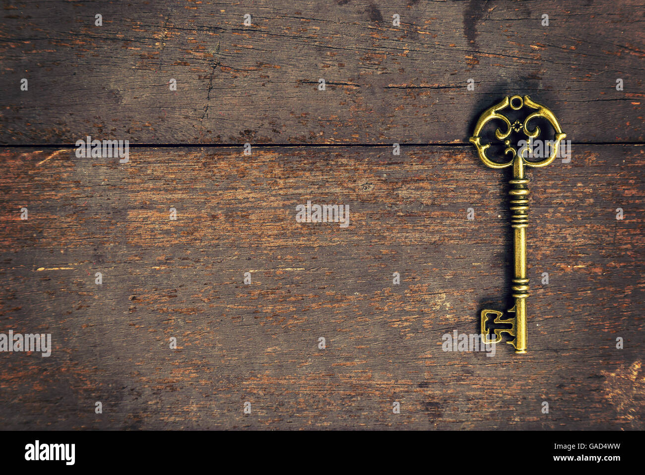 Old vintage key on wood texture background with space Stock Photo - Alamy