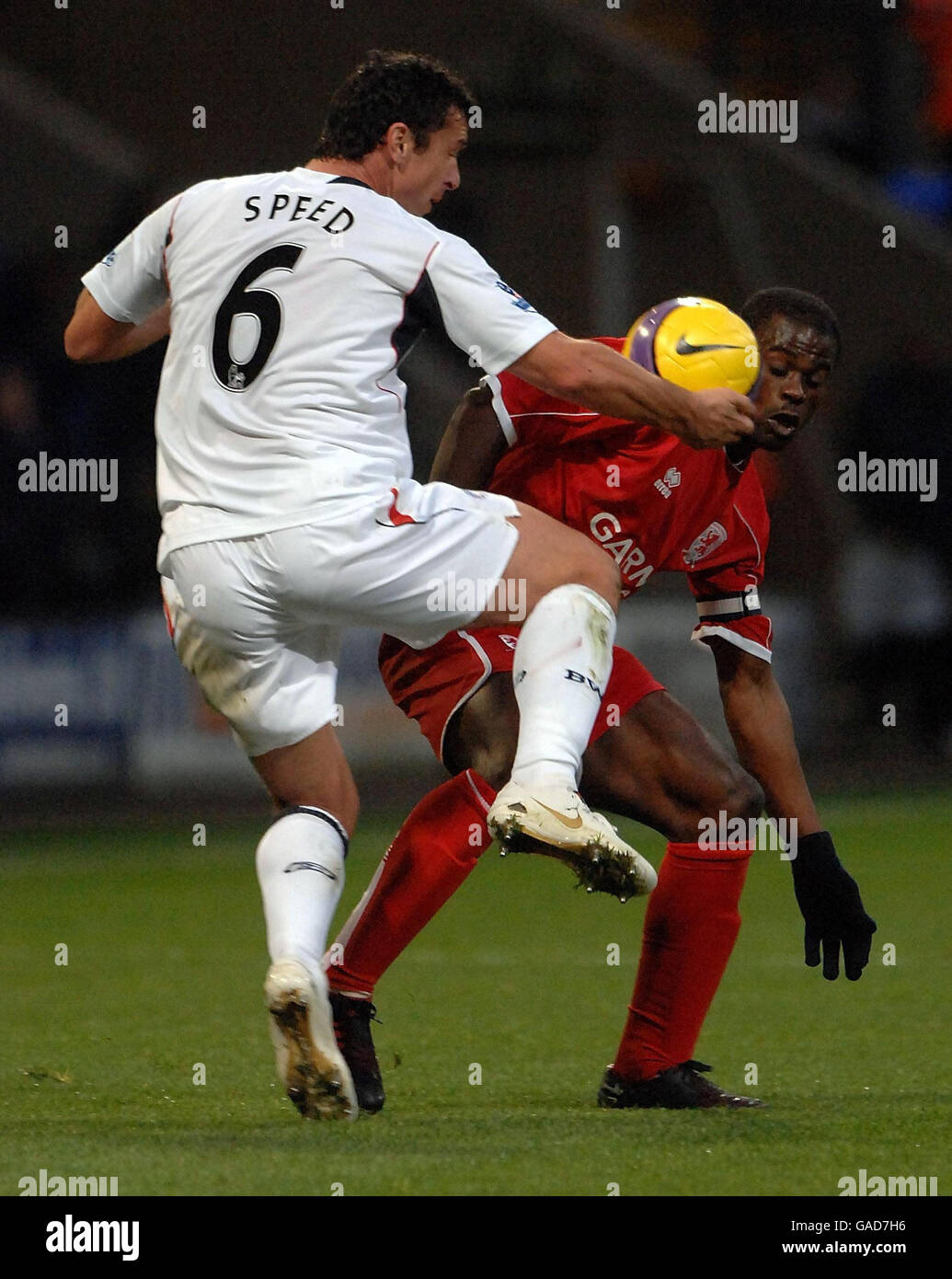 Bolton's Gary Speed challenges Middlesbrough's George Boateng (right ...