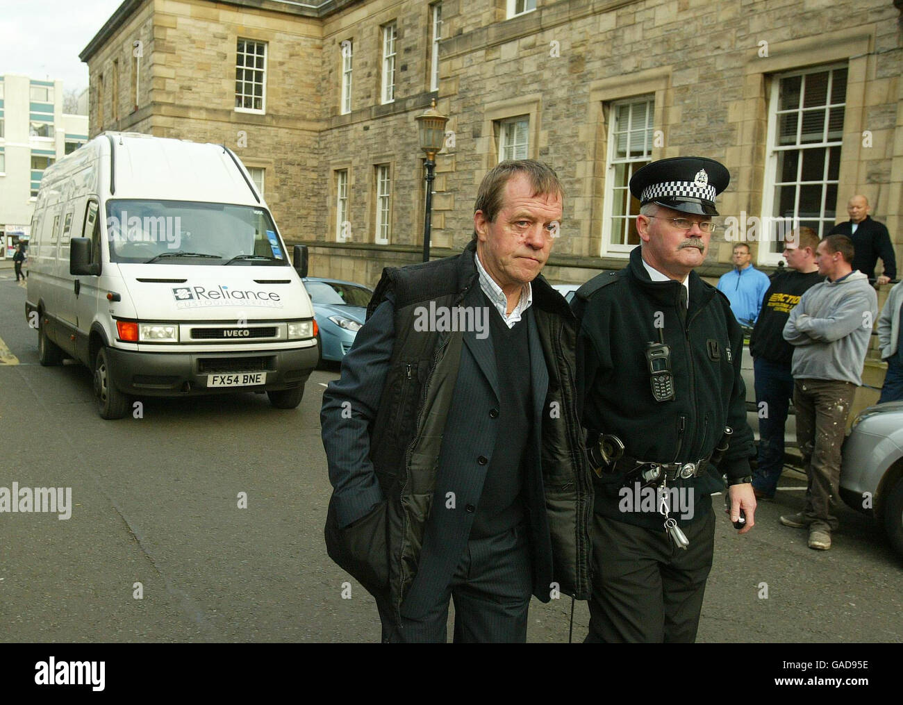 Michael Hamilton walks up in front of the van carrying Peter Tobin as ...