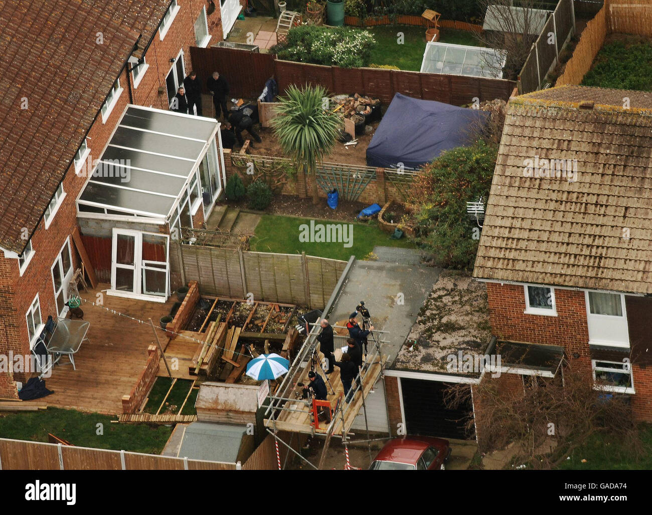 Dig goes on at house after body discovery Stock Photo - Alamy