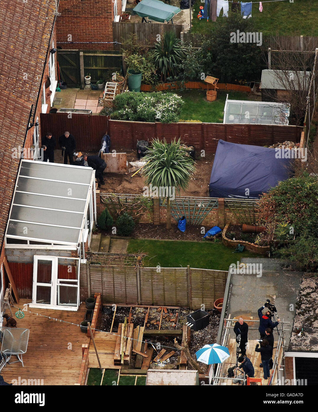 Dig goes on at house after body discovery Stock Photo - Alamy