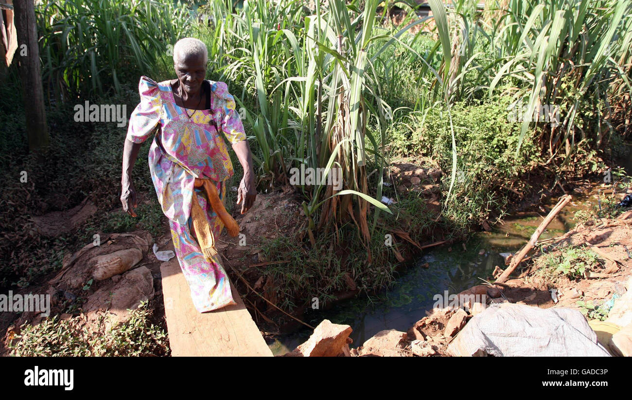 An old woman crosses a bridge in Natete, a slum on the outskirts of ...
