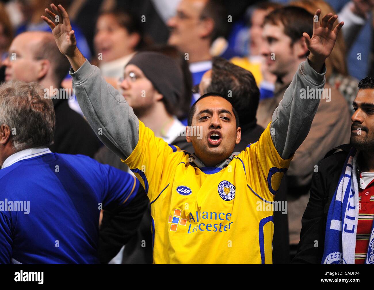 Leicester city fans cheer on their team from the stands hi-res stock ...