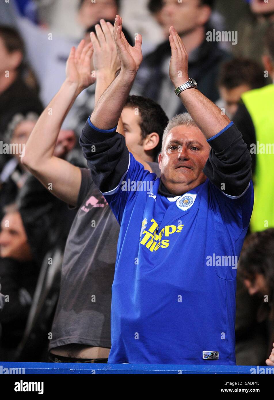Leicester city fans cheer on their team from the stands hi-res stock ...
