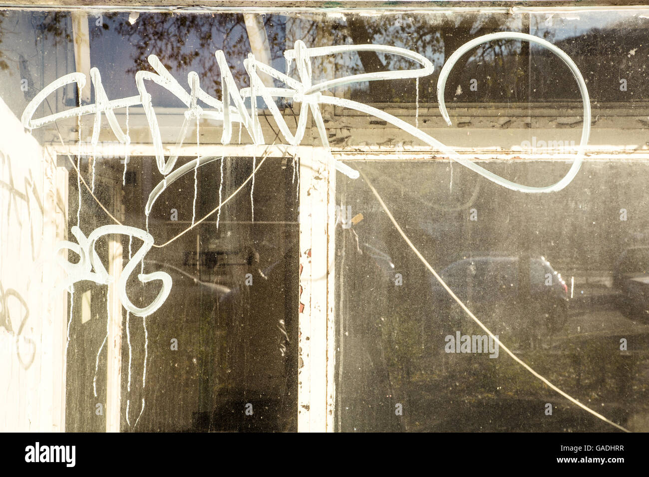 A dirty window with some graffiti Stock Photo - Alamy