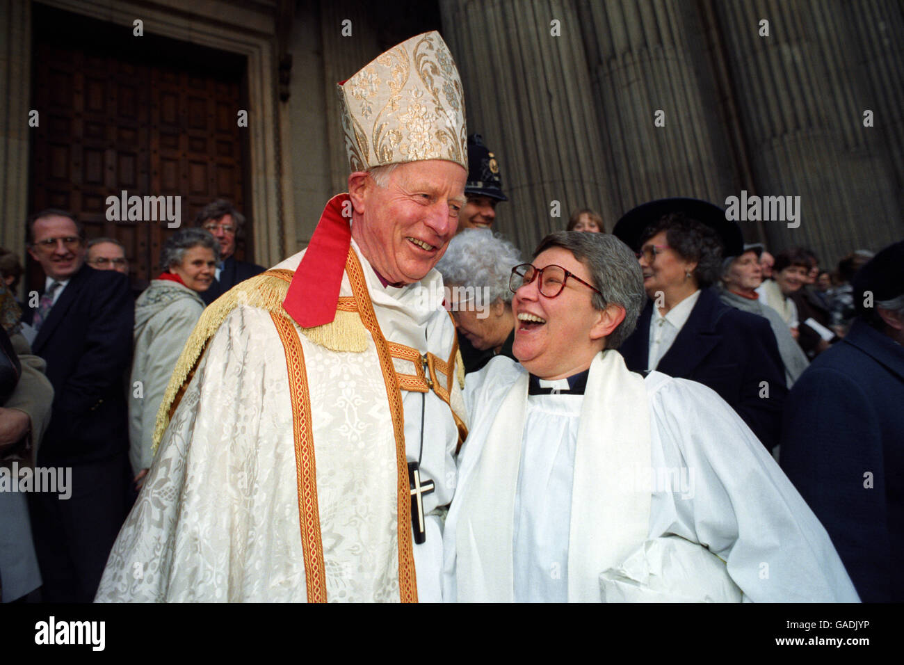 A jubilant newly ordained priest shares a joke with the assistant ...