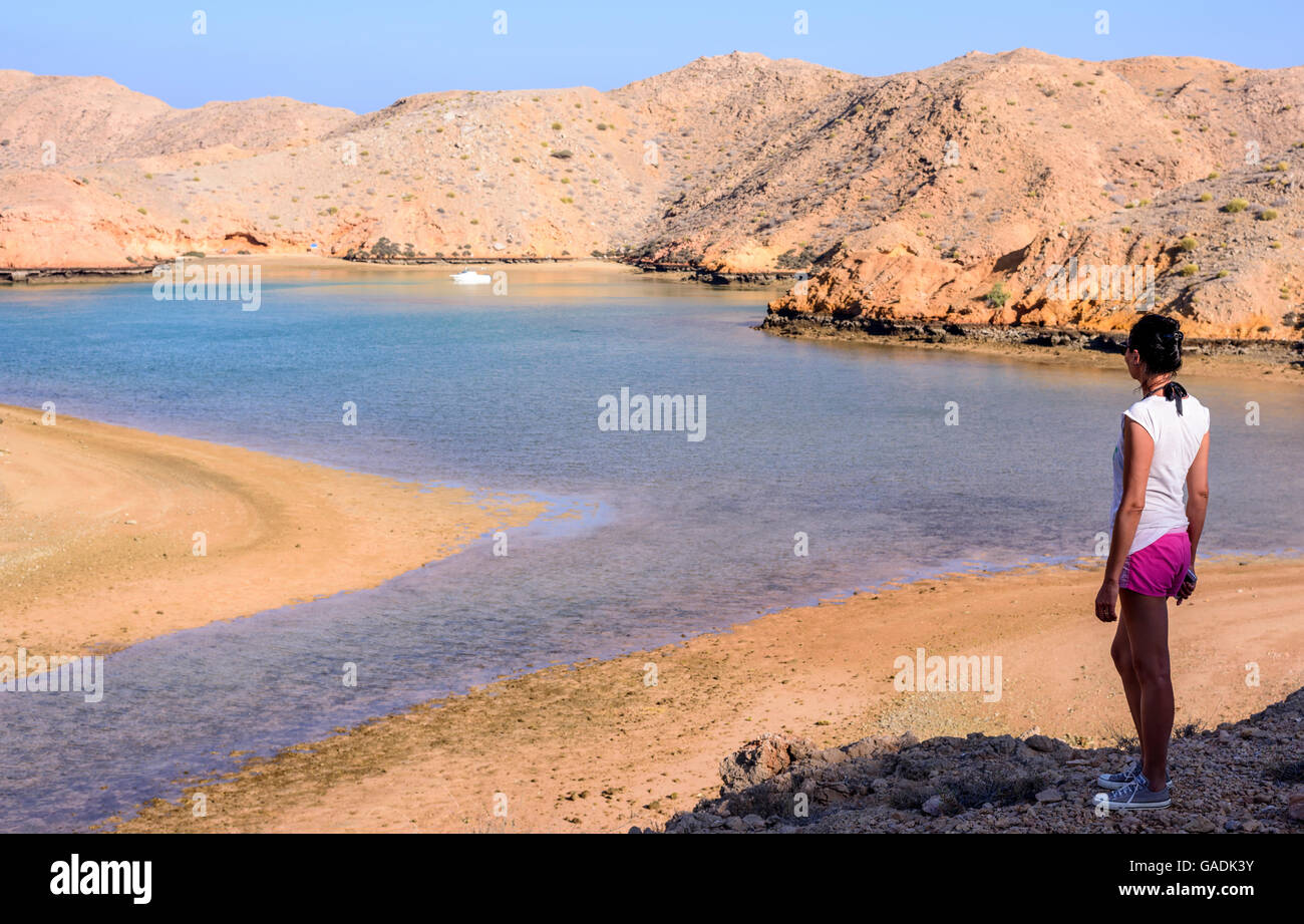 A tourist lady looking at a scenic fjord-like during low tide in Bandar ...