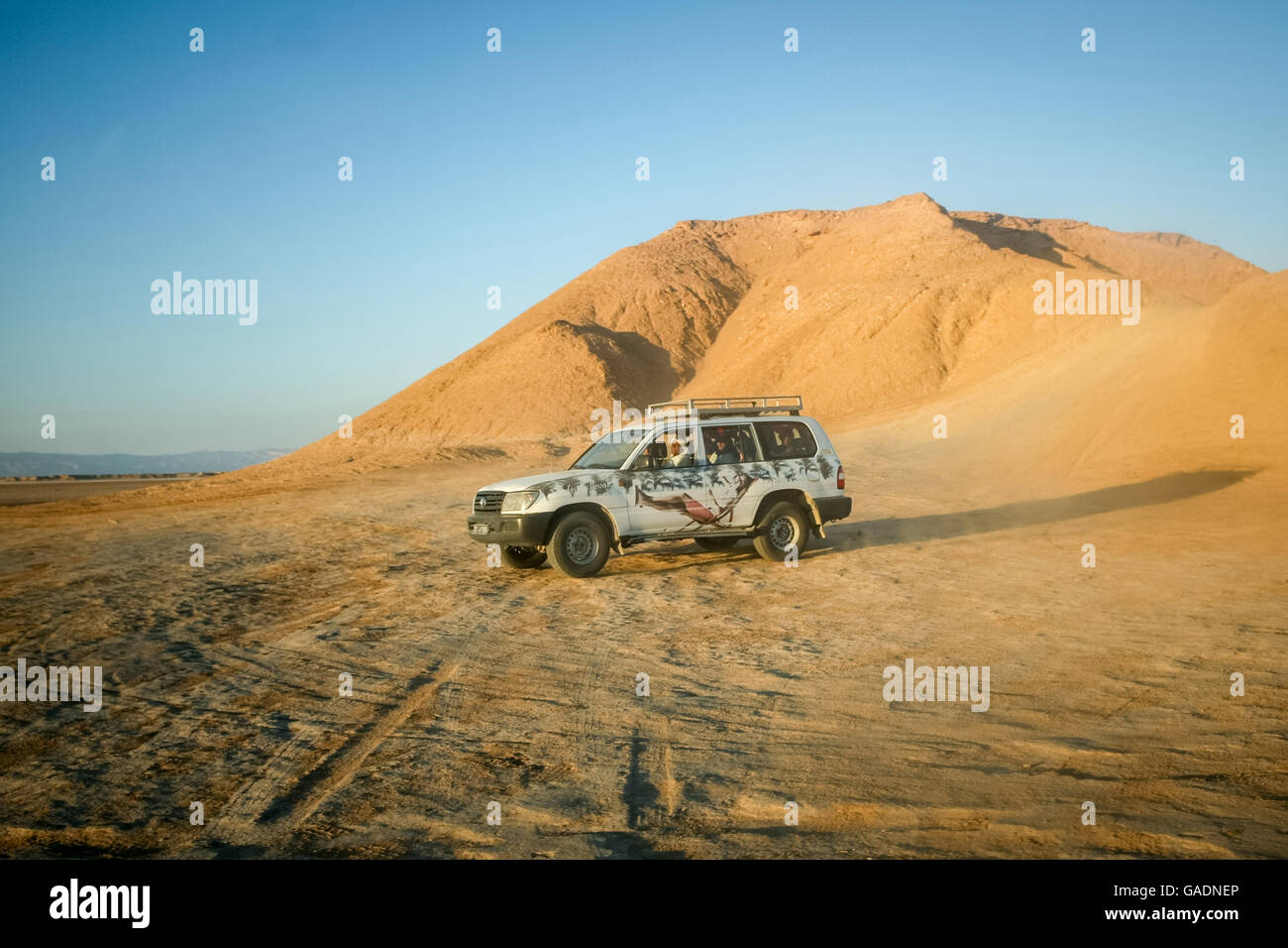 A jeep driving tourists on adrenaline ride on the dunes of the Sahara ...