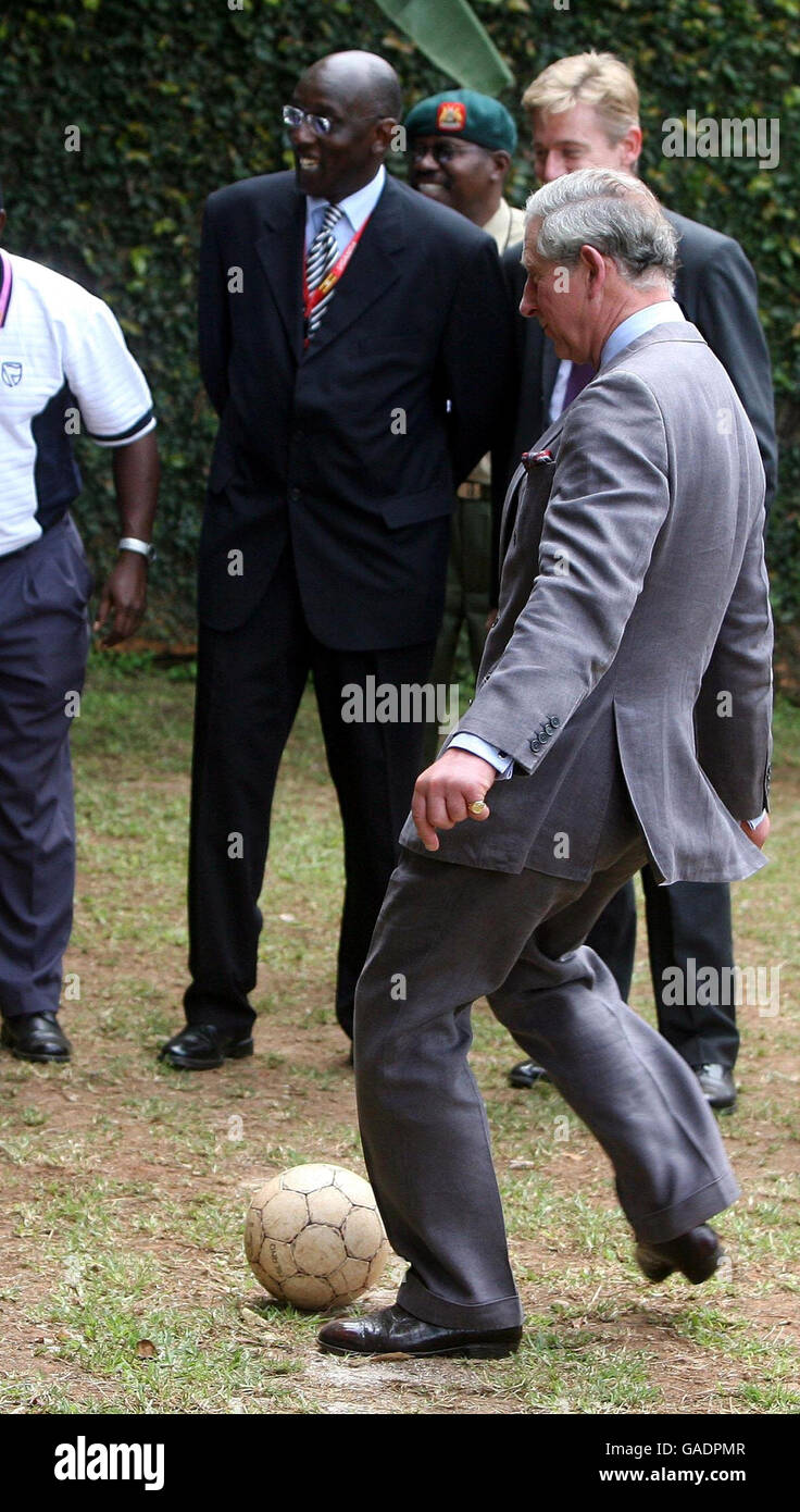 Prince Charles passes a football with Ugandan children at the Kampala ...