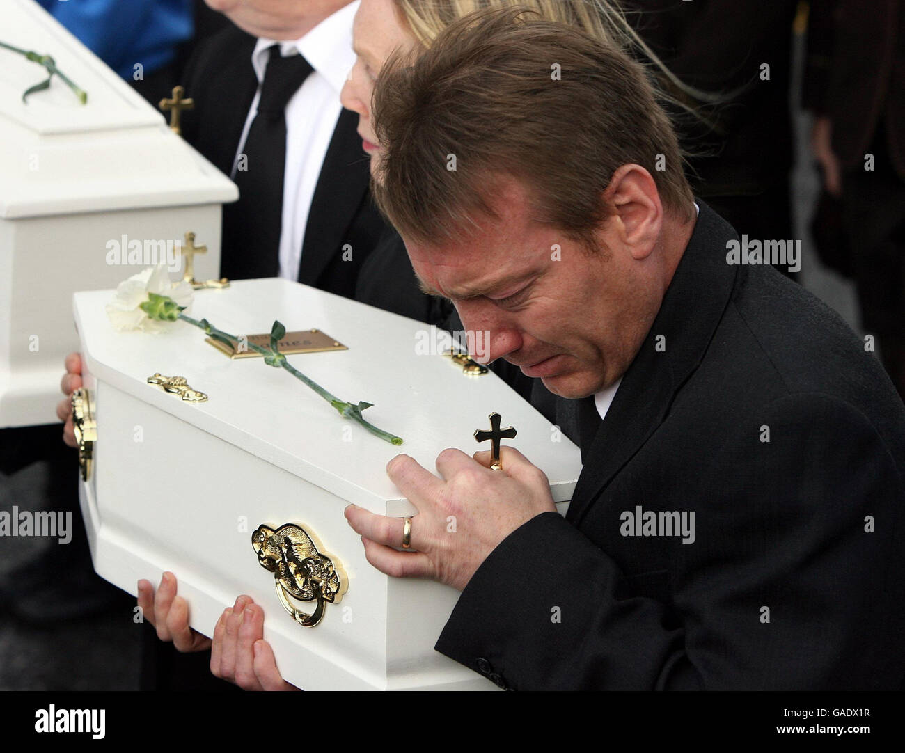 An unidentified member the McEhill family carries nine-month-old baby ...