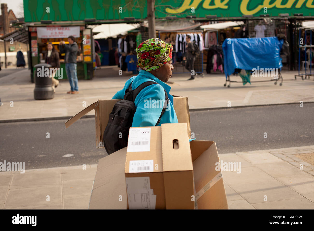 Woman carrying boxes through London streets Stock Photo - Alamy