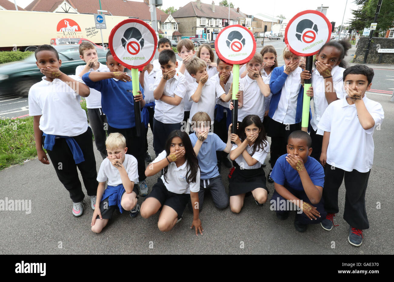 Pupils from Bowes Primary School in Enfield, north London, cover their ...