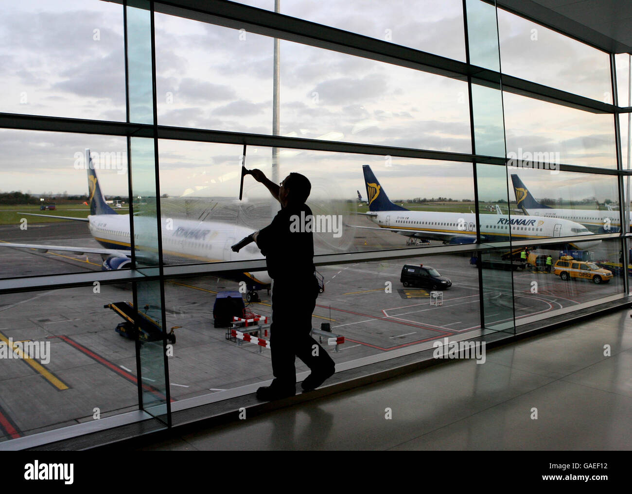 Airport extension unveiled. A window cleaner puts the finishing touches ...