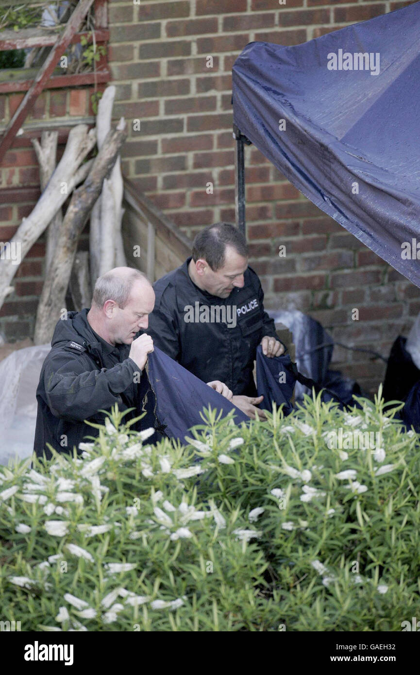 Dig goes on at house after body discovery Stock Photo - Alamy