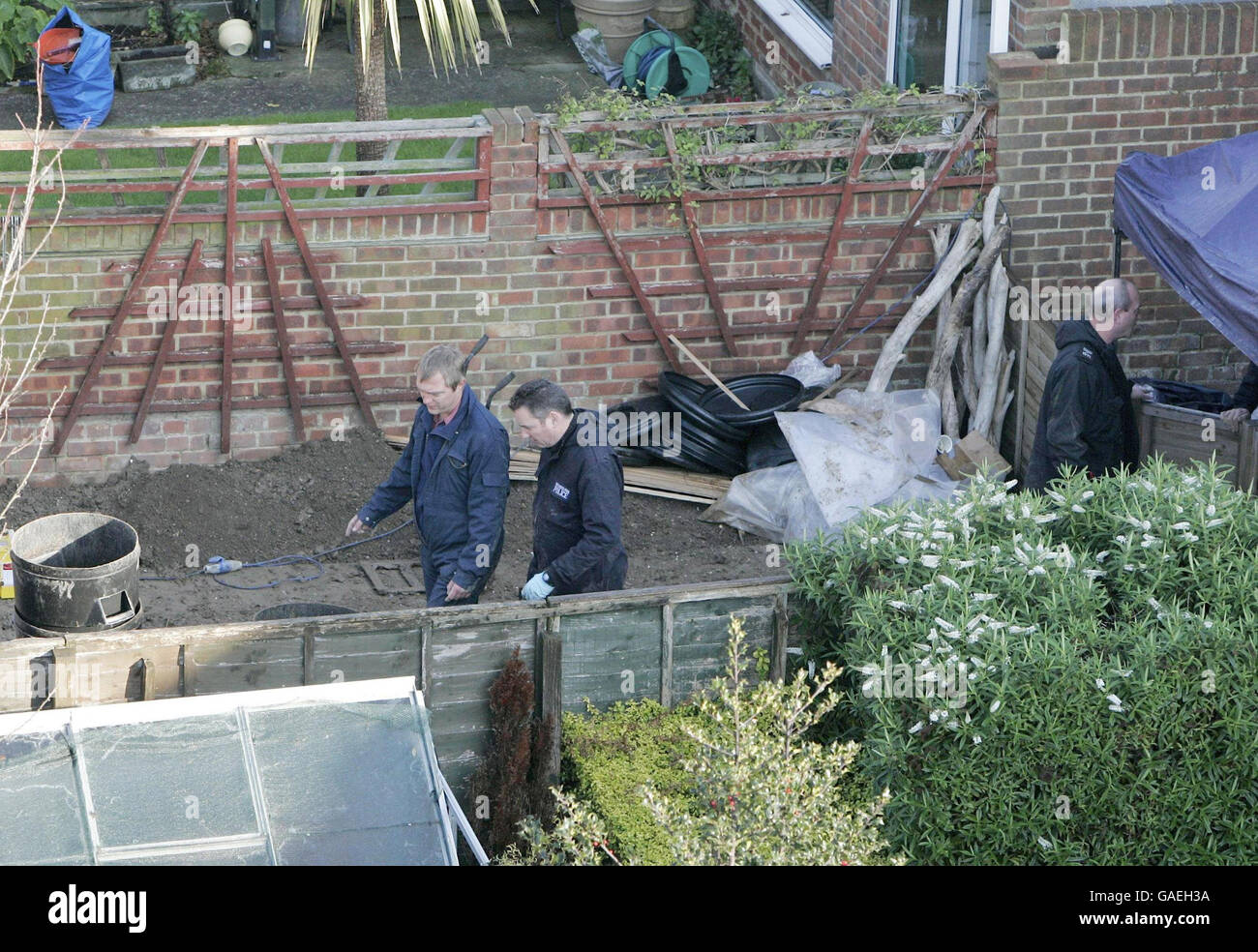 Dig goes on at house after body discovery Stock Photo - Alamy
