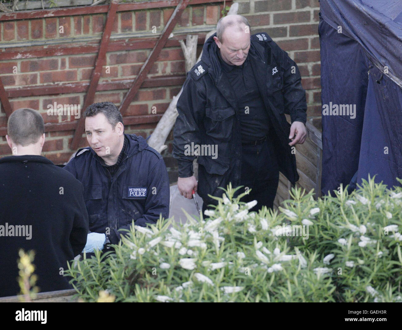Dig goes on at house after body discovery Stock Photo - Alamy