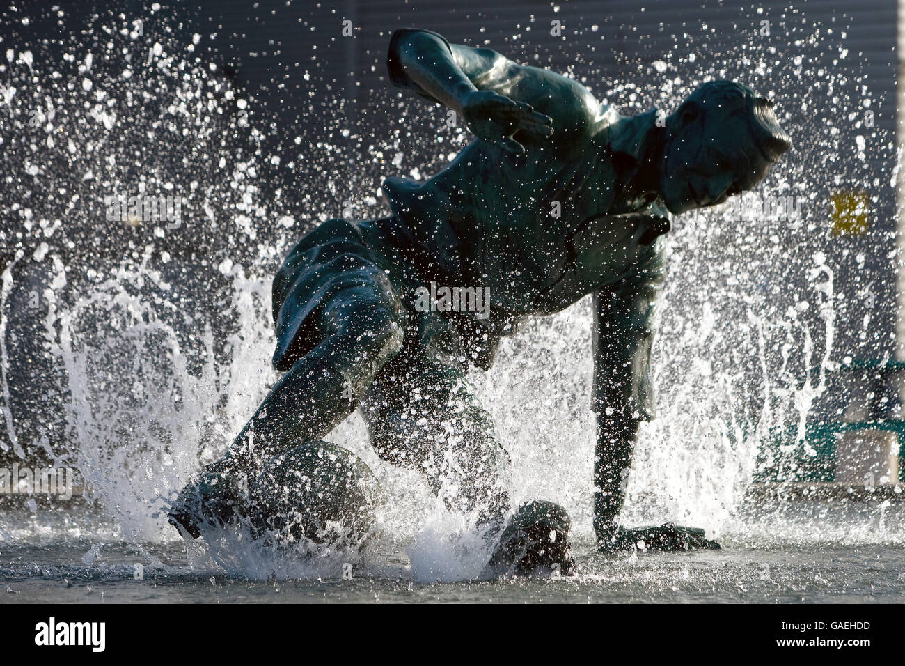 A statue of Preston North End's Tom Finney splashing through a puddle ...