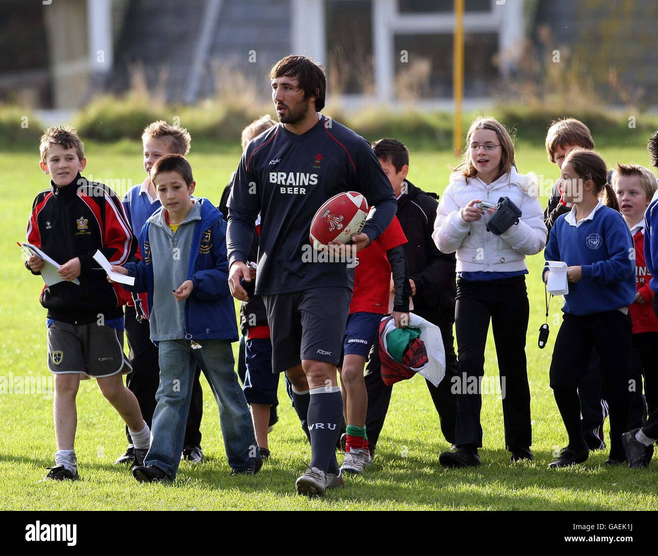 Wales' centre Gavin Henson leads the autograph hunters around Tenby ...