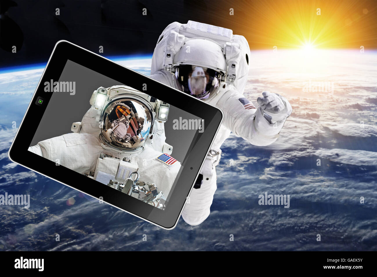 Astronaut in outer space with tablet - Elements of this image furnished ...