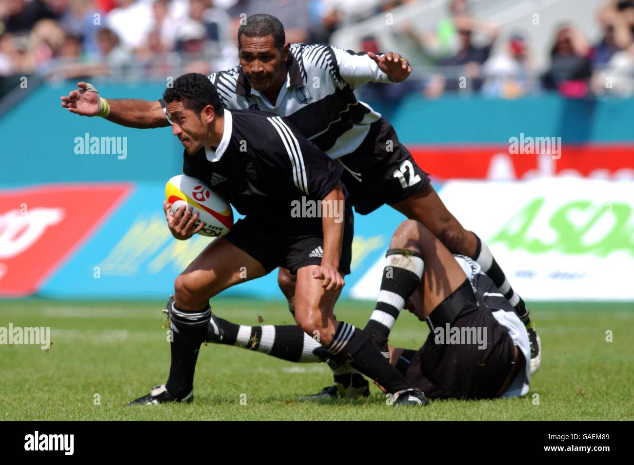 New Zealand's Mils Muliaina comes away from Fiji's Jope Tuikabe Stock ...