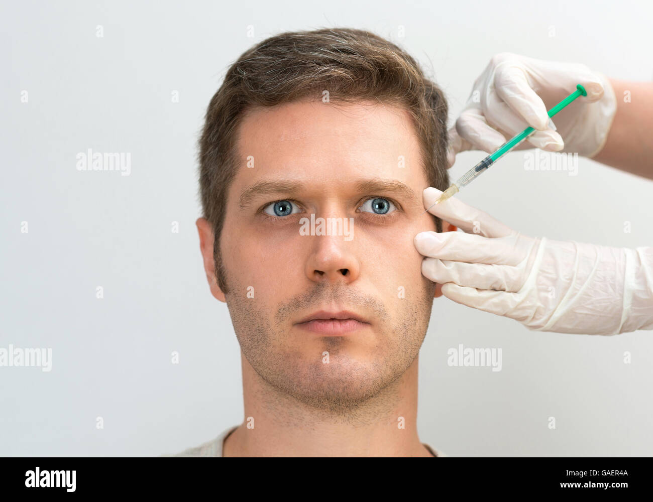 Handsome man is getting injection. Concept of aesthetic beauty. Place ...