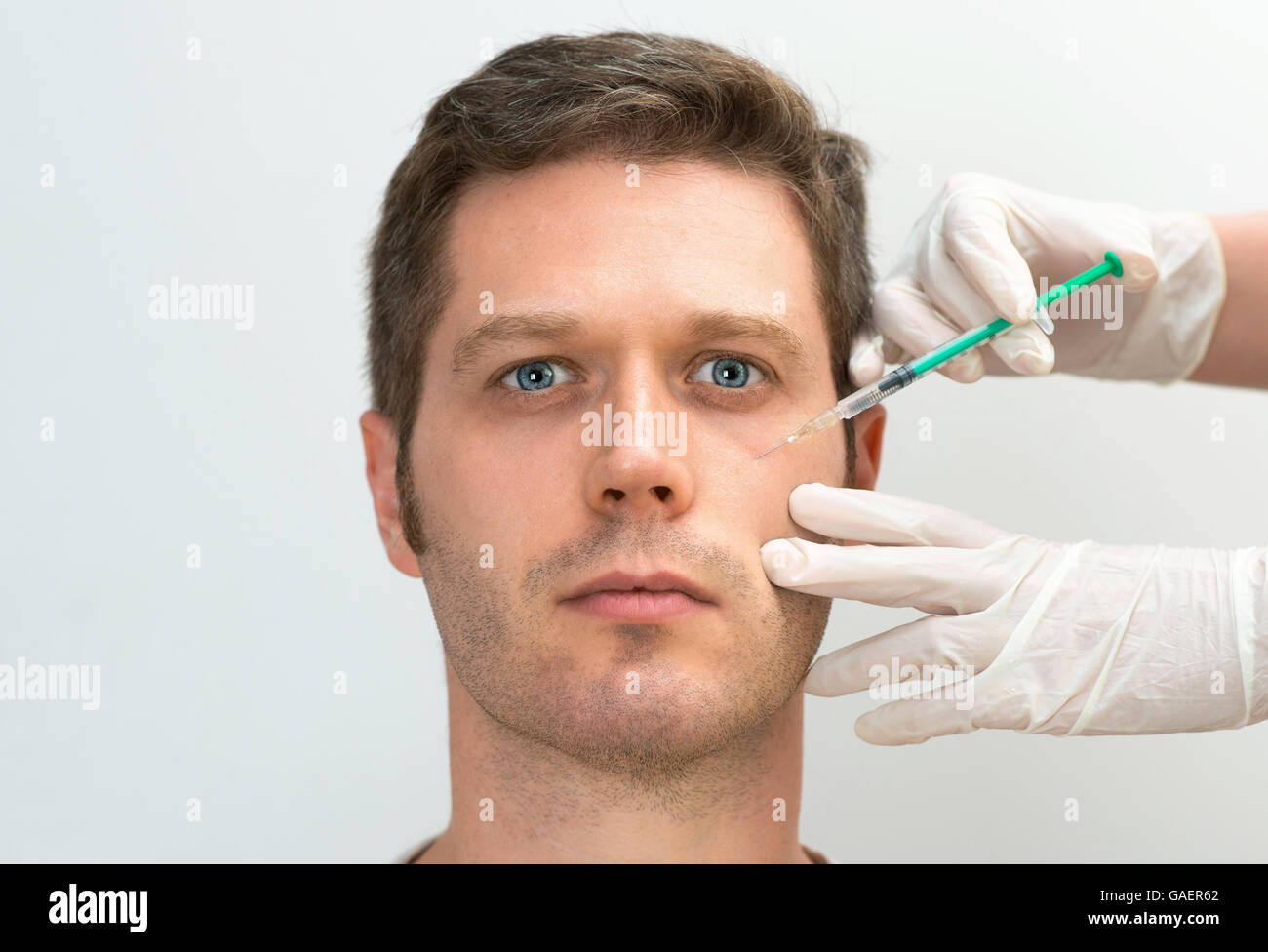 Handsome man is getting injection. Concept of aesthetic beauty. Place ...