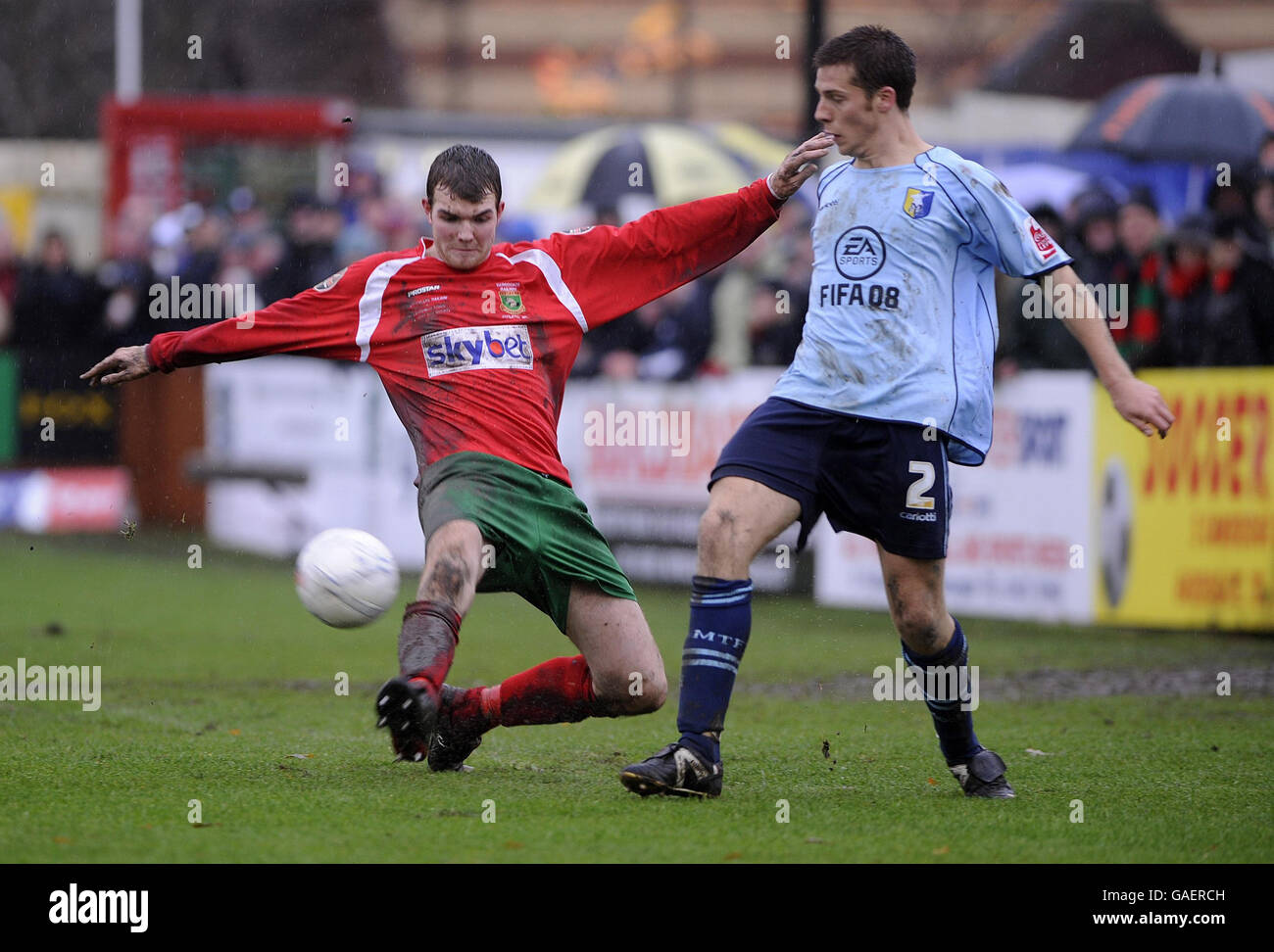 Harrogate Railway's James Riley (left) puts in a strong challenge on ...