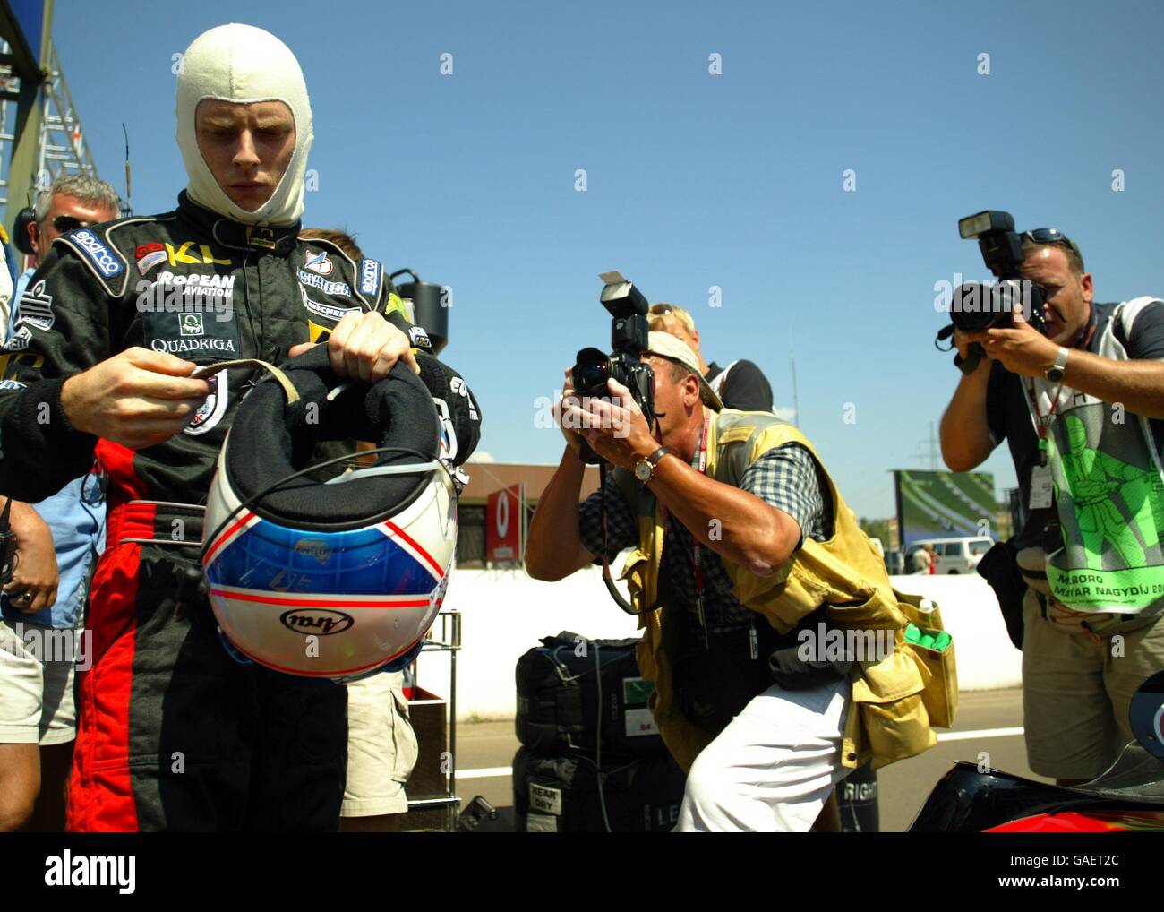Minardi's new British driver Anthony Davidson stands on the grid ...