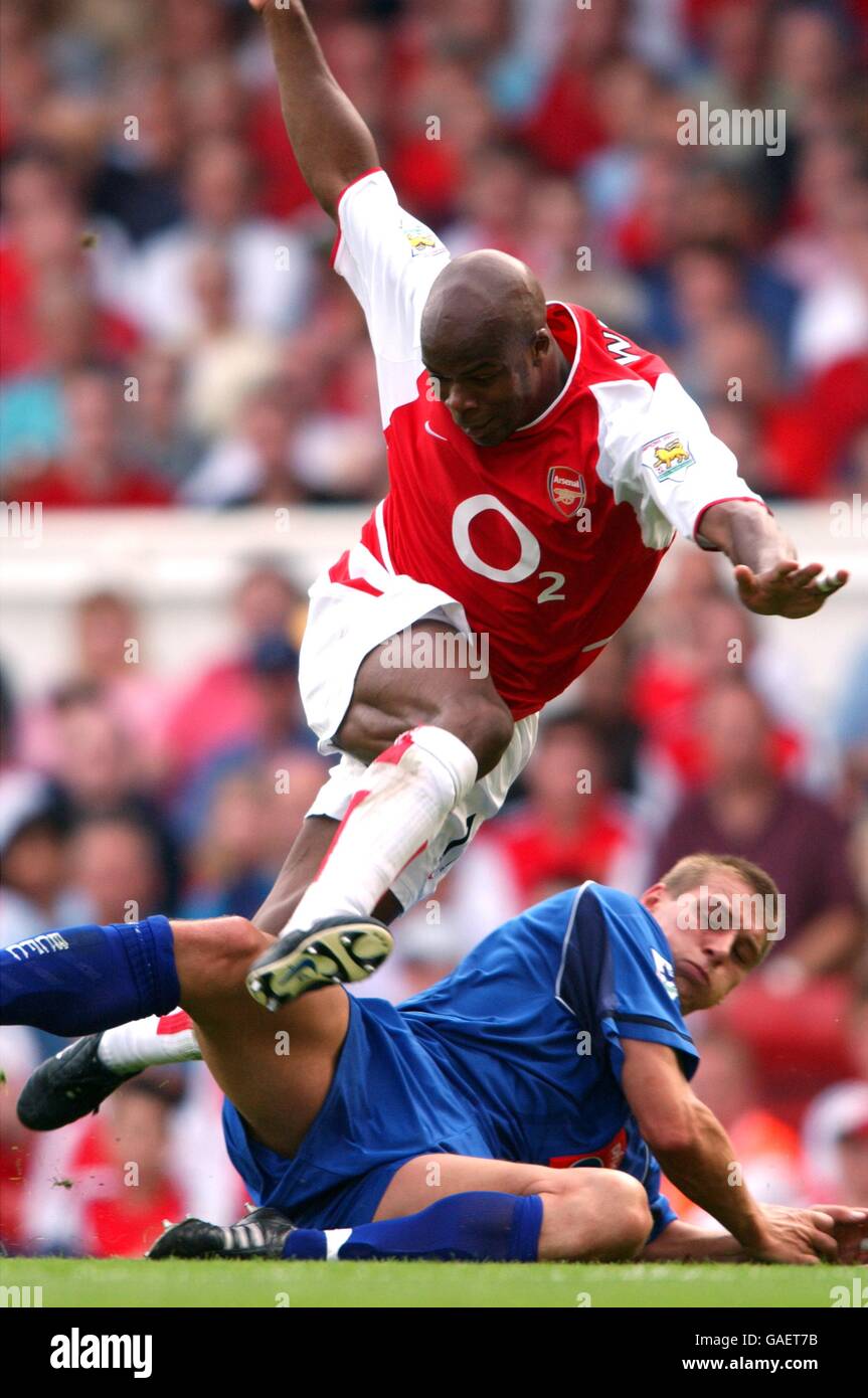 Arsenal's Sylvain Wiltord is tackled by Birmingham City's Darren Purse ...