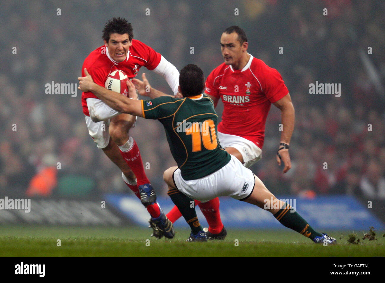 Wales' James Hook (left) gets away from South Africa's Andre Pretorius ...