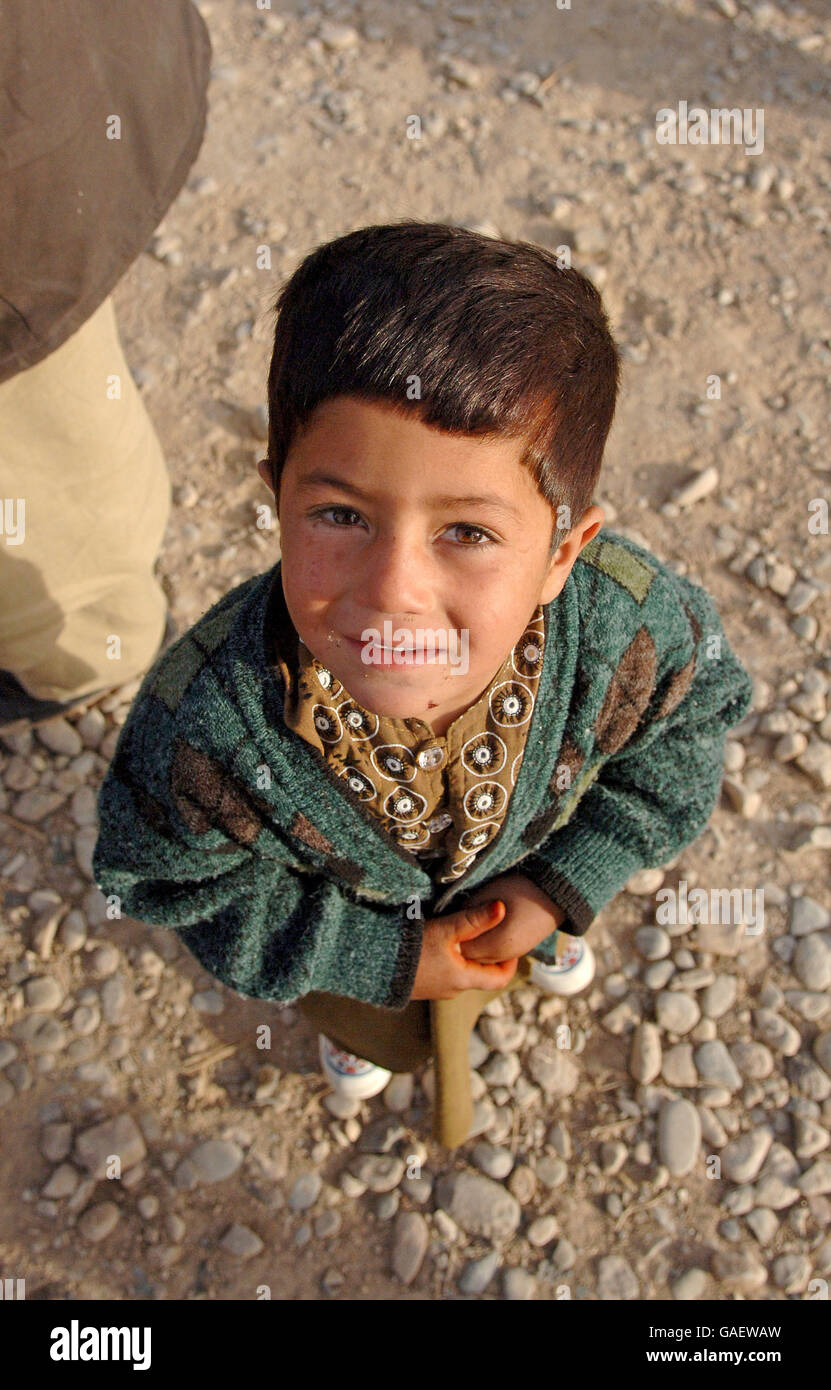 A local Boy poses for the camera as Royal Marine Commando's patrol ...