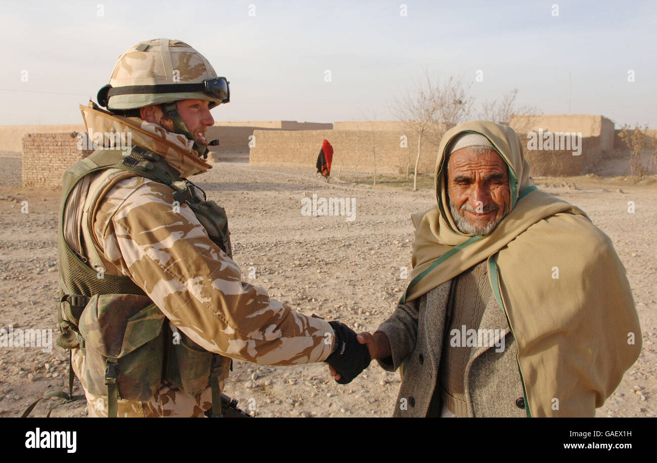 Royal Marine Commando meets a local man while patroling near the ...