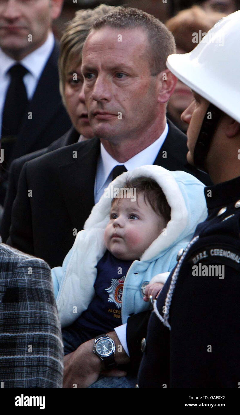 Baby George Stephens is carried by his grandfather Ian Crockeras as the ...