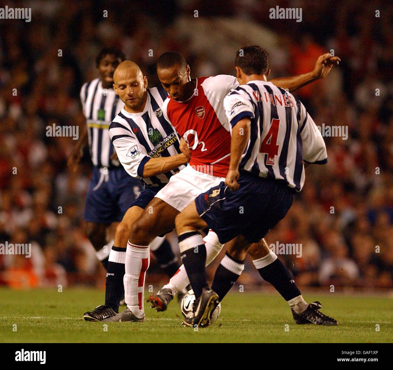 Arsenal's Thierry Henry sandwiched between West Bromwich Albion's Larus ...