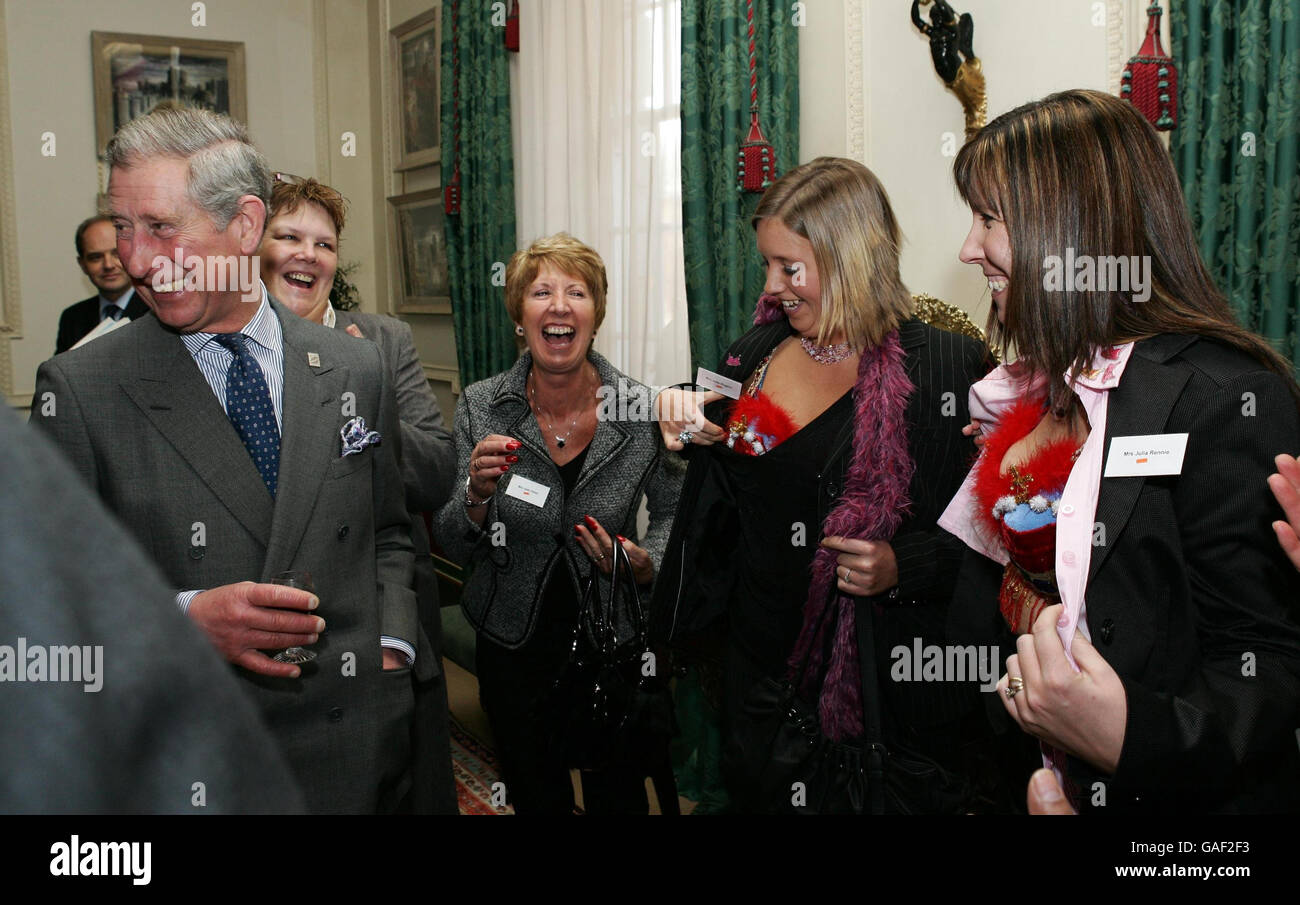 The Prince of Wales laughs after (left to right) Julie Rogers, and ...