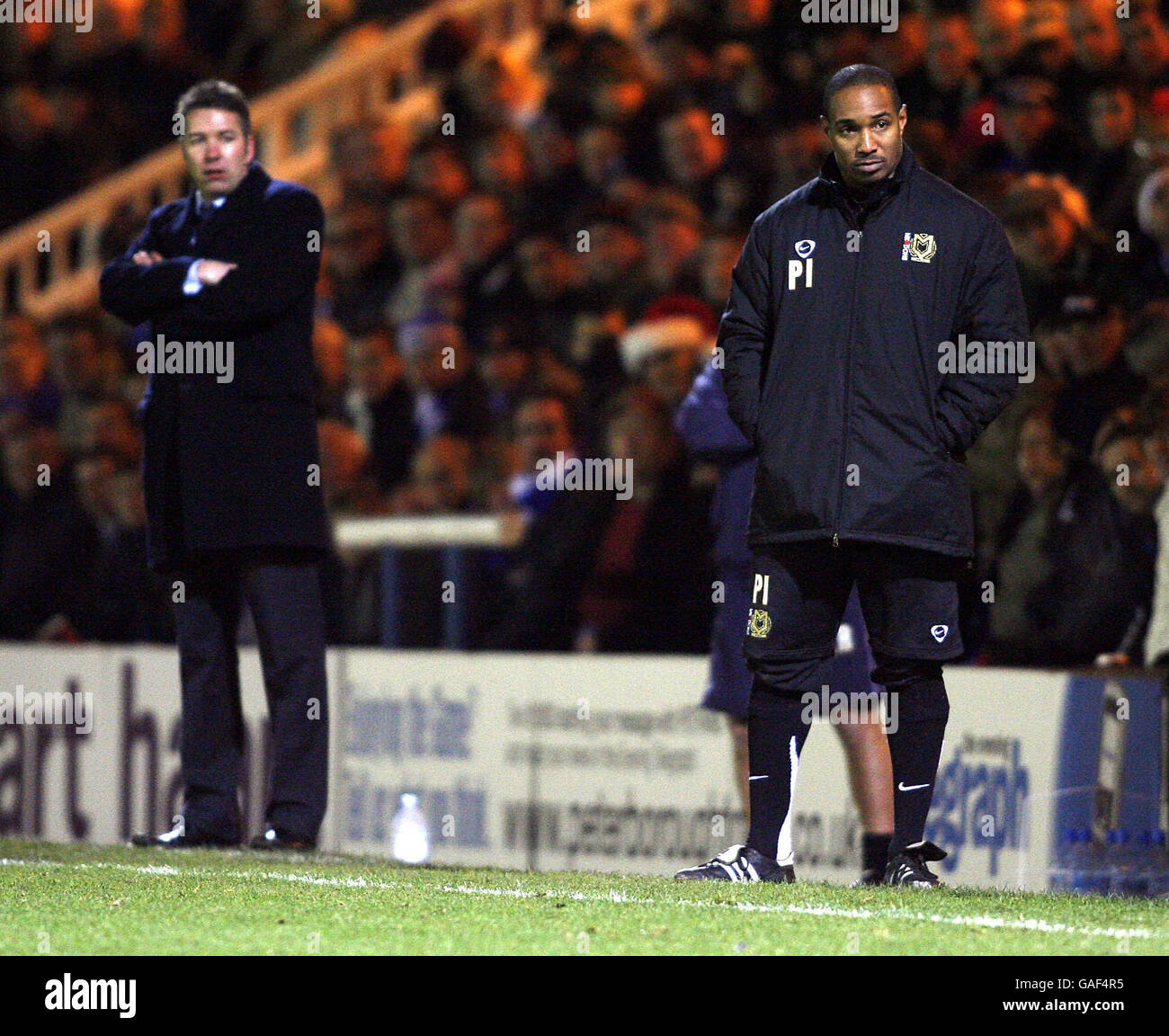 Paul Ince the manager of MK Dons stands on the touch-line with Darren ...