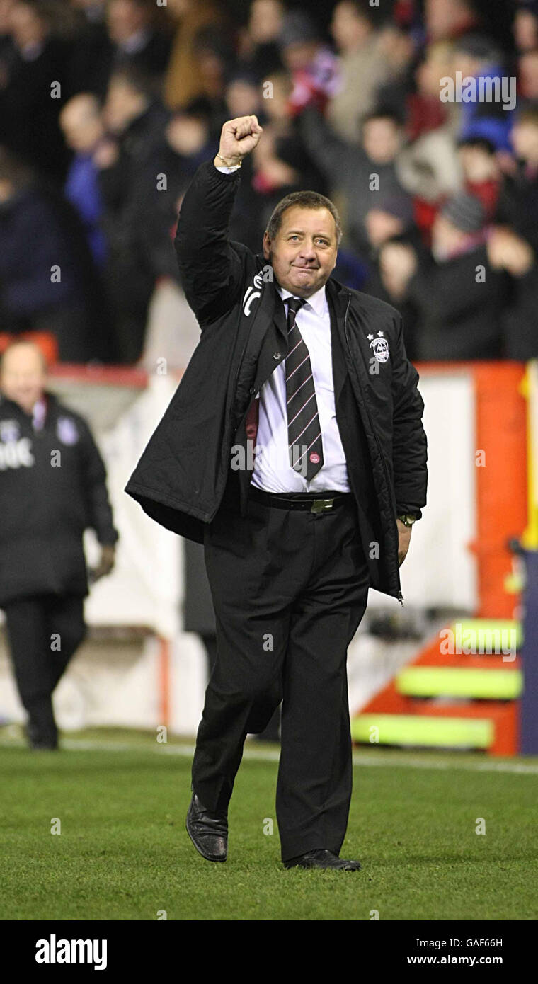 Aberdeen's manager Jimmy Calderwood salutes the crowd after the clash ...