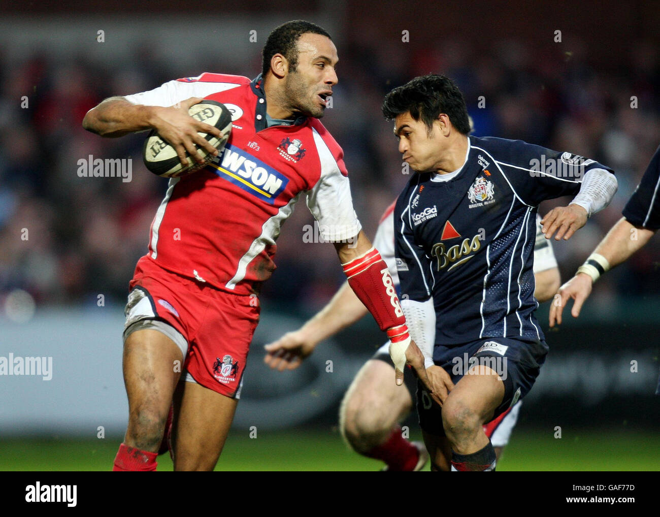 Gloucester's Leon Lloyd tries to escape the clutches of Bristol's David ...